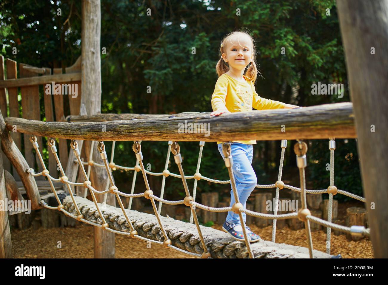 Happy 3 years old girl playing on a playground. Outdoor summer ...