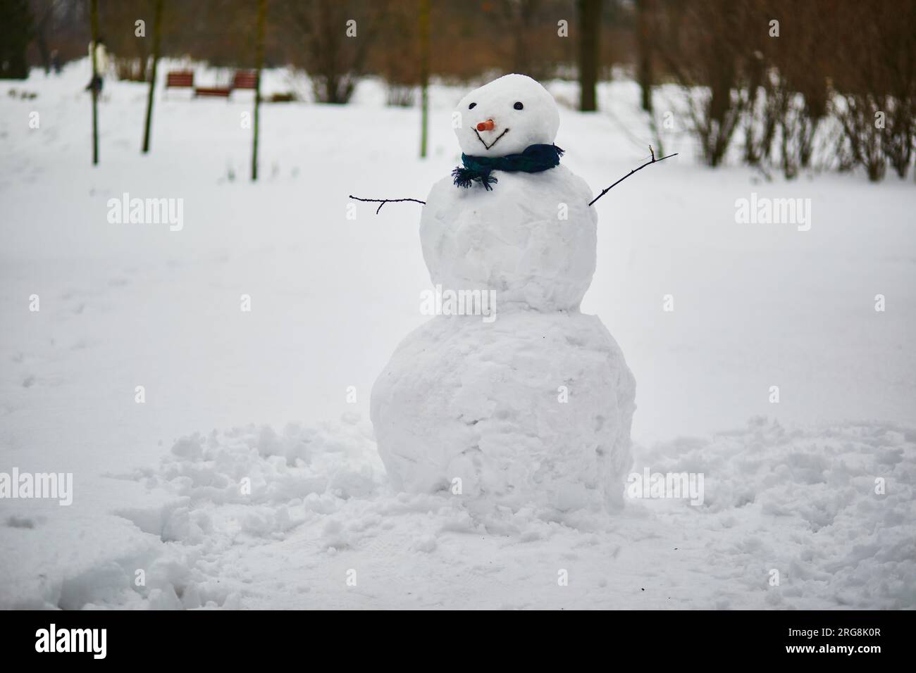 Big snowman with happy face, carrot nose and scarf on a winter day ...