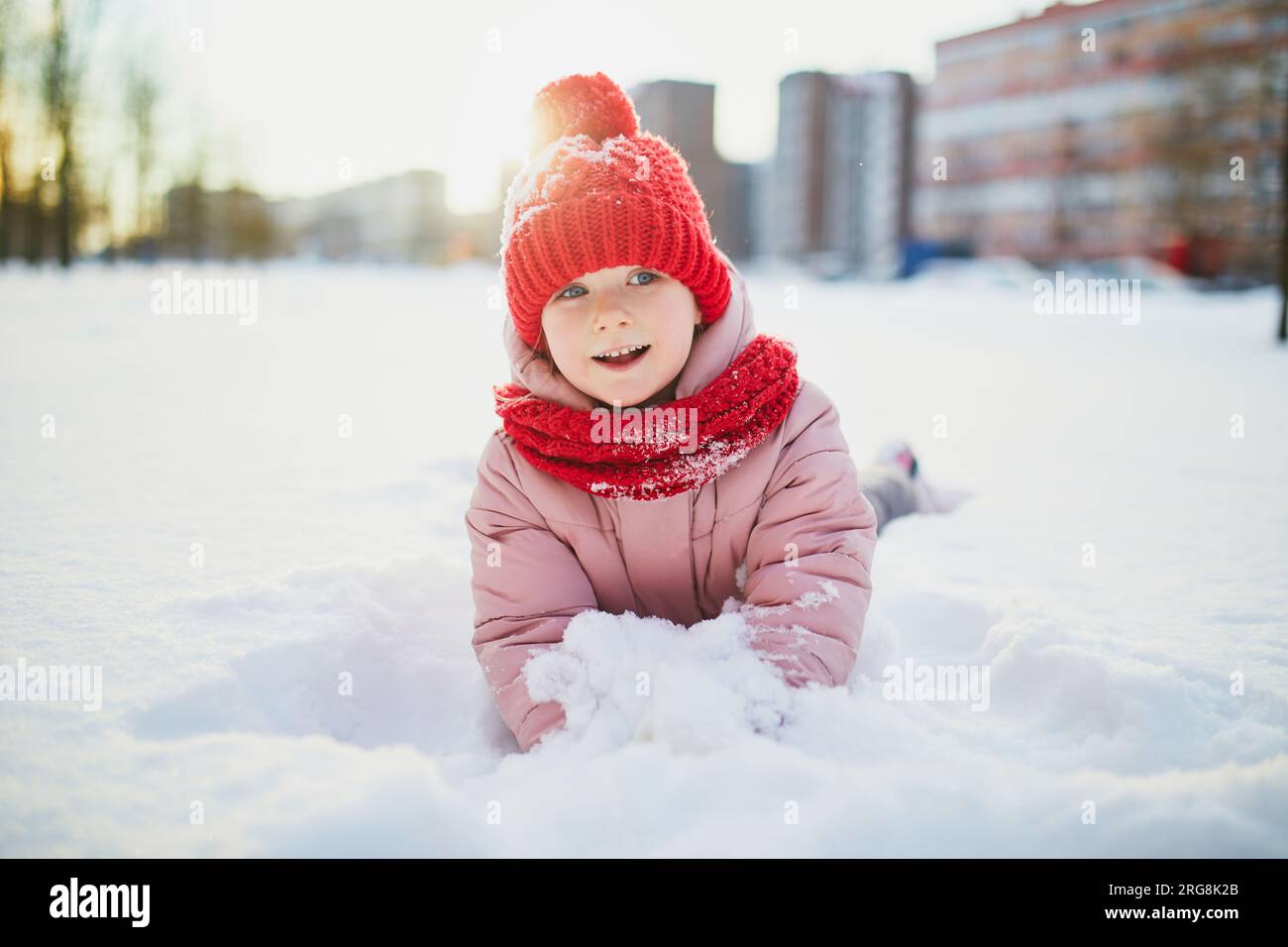 Adorable preschooler girl having fun in beautiful winter park on a ...