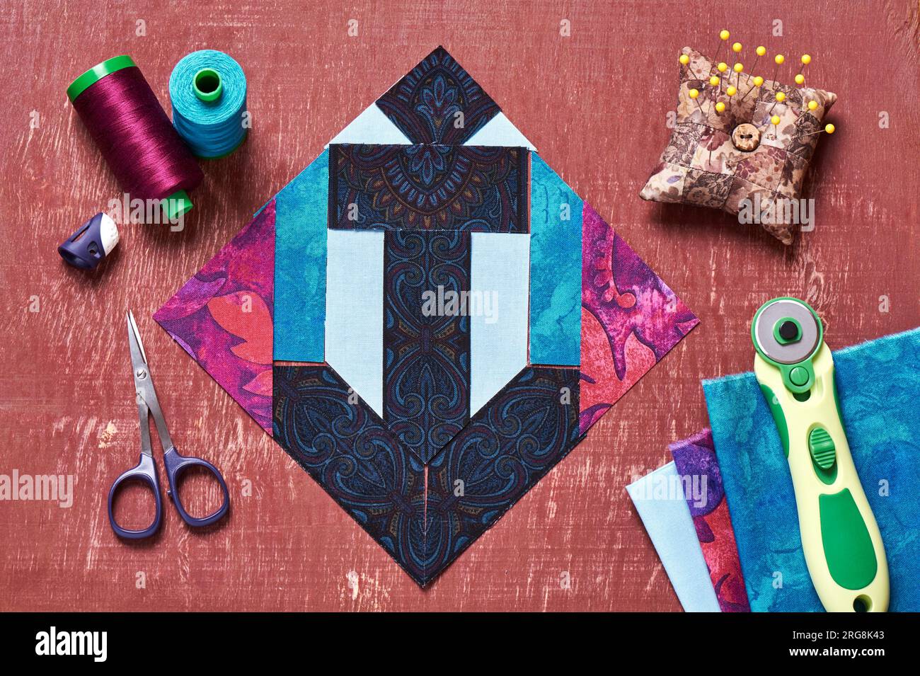 Sewing patchwork of block anchor surrounded by accessories Stock Photo ...
