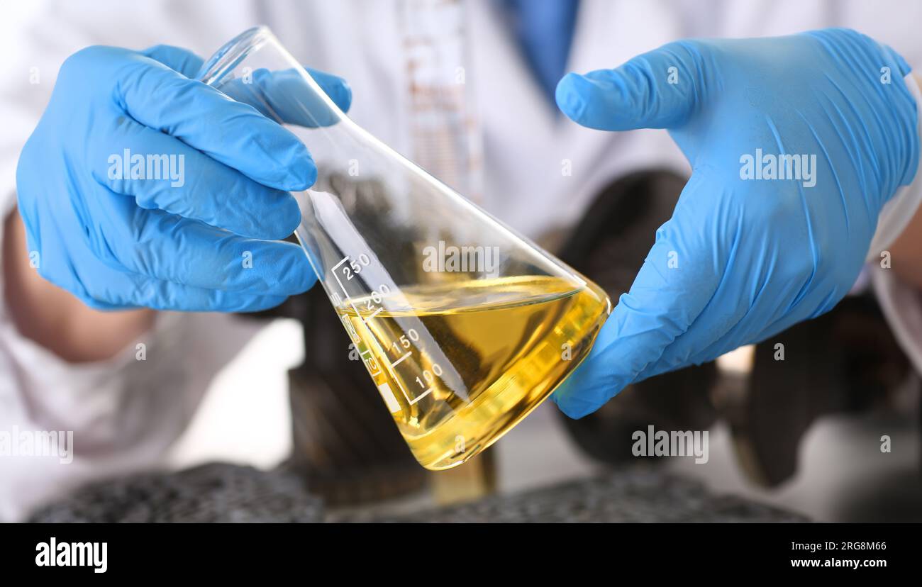 Male hands in protective gloves hold test tube Stock Photo - Alamy