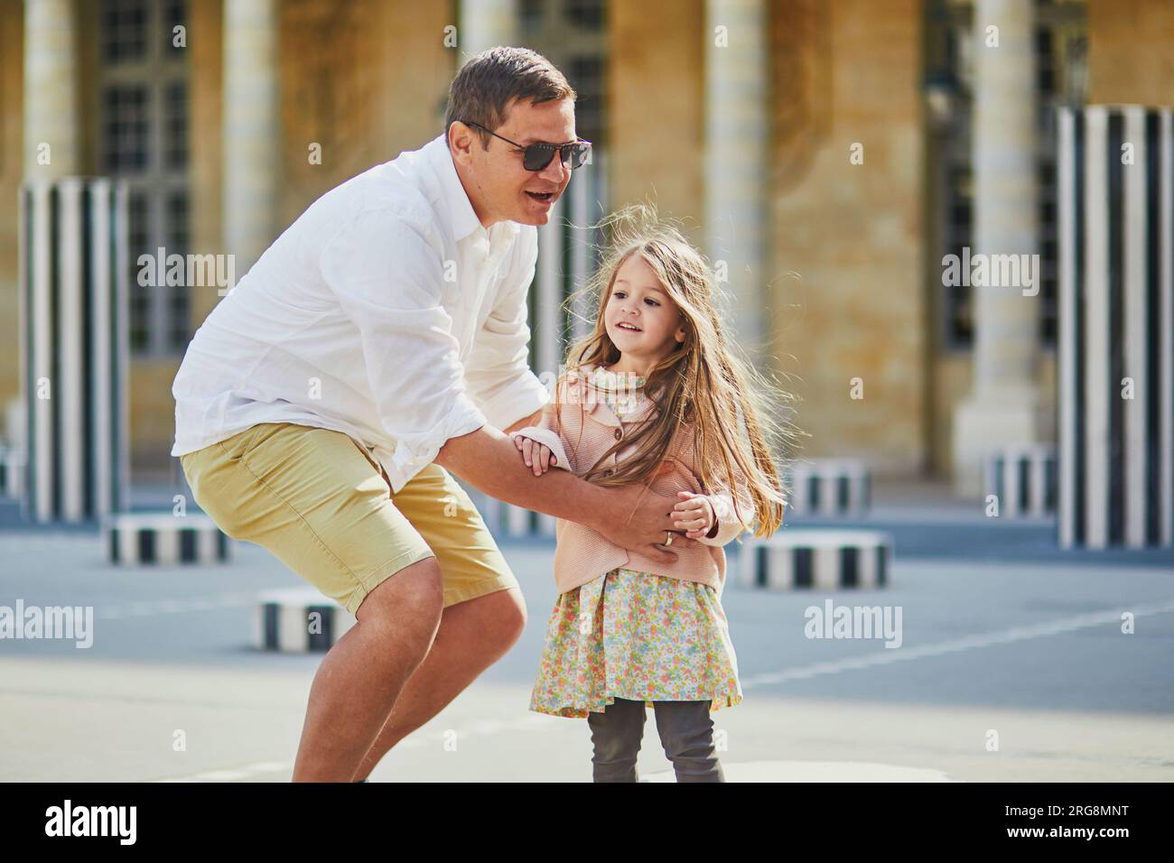 Happy family of two on a street of Paris. Father with his adorable 4 ...
