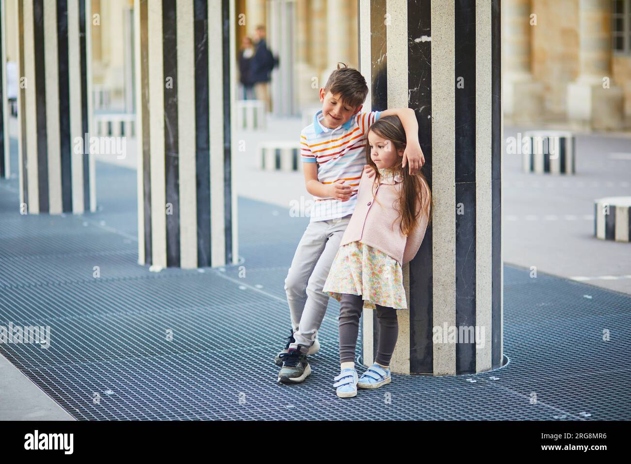 Girl and boy playing in Palais Royal garden. Brother and sister having ...
