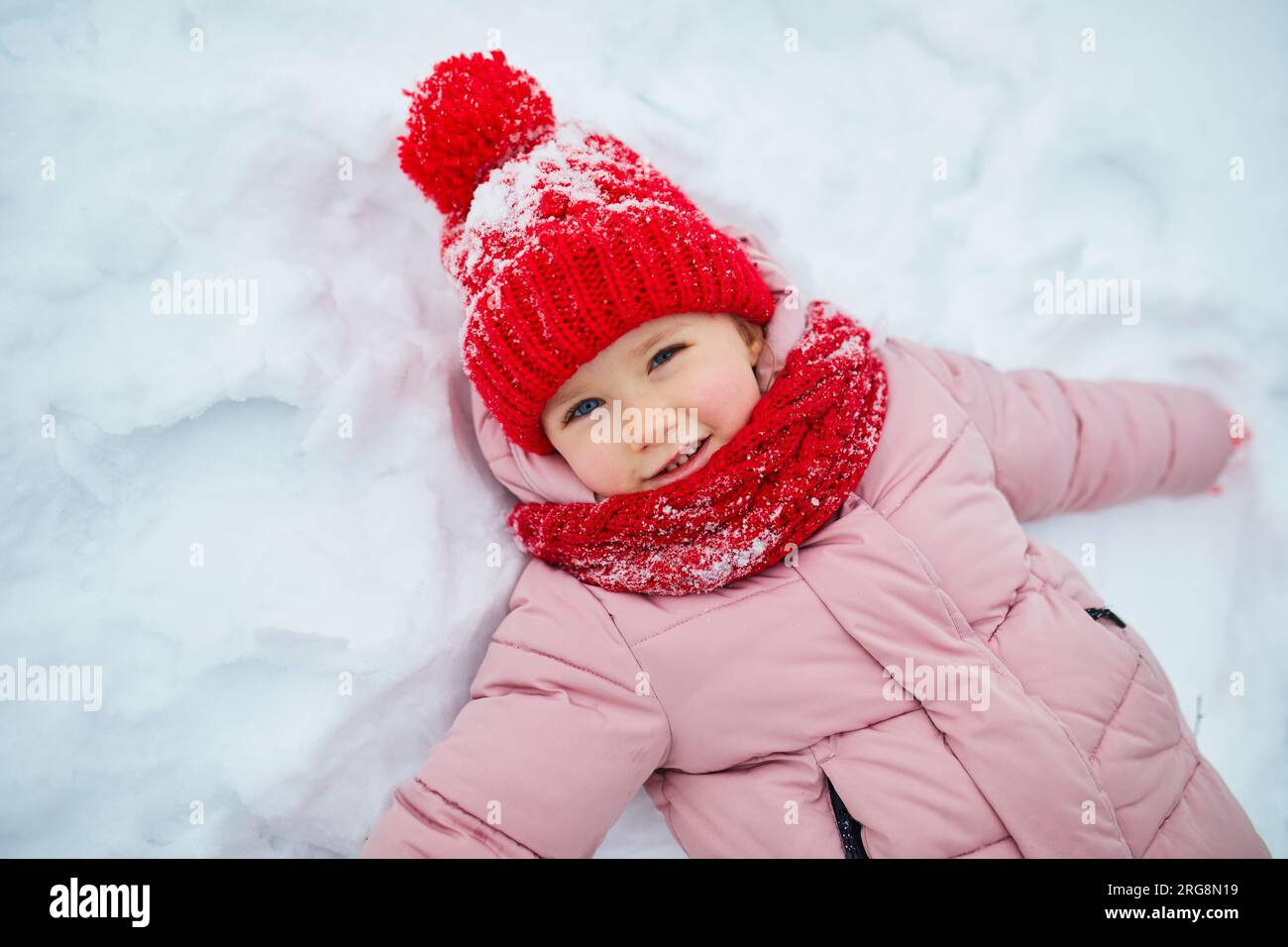 Adorable preschooler girl having fun in beautiful winter park on a ...