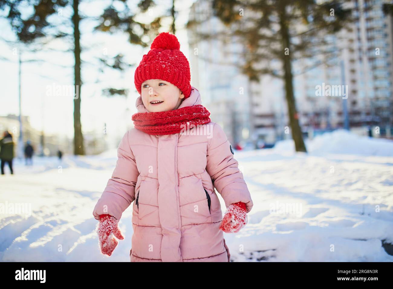 Adorable preschooler girl having fun in beautiful winter park on a ...