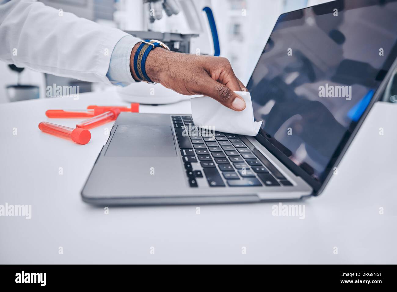 Man, hands and scientist cleaning laptop in disinfection, bacteria or ...