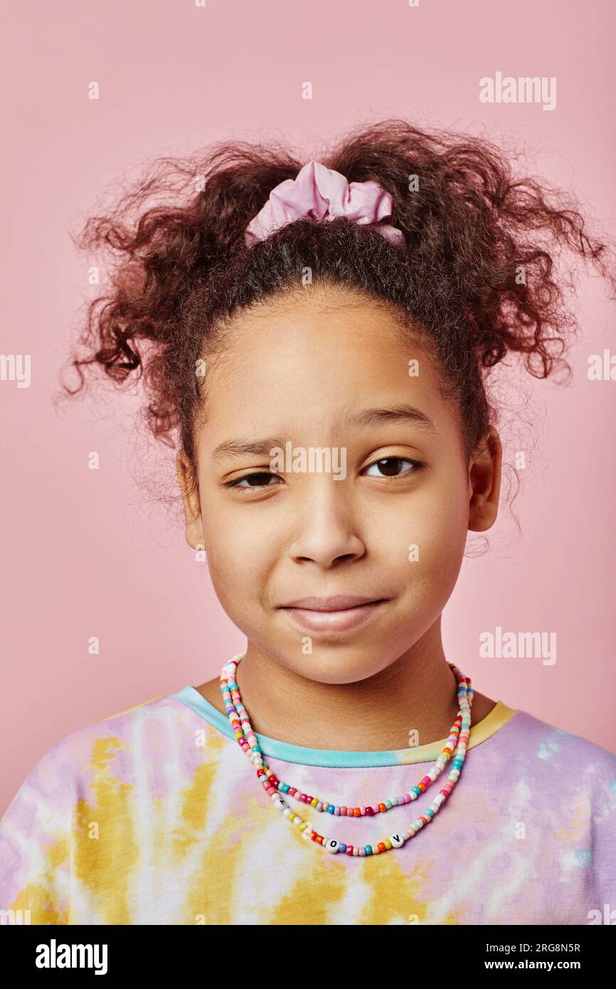 African American cute girl with necklace looking at camera while posing ...