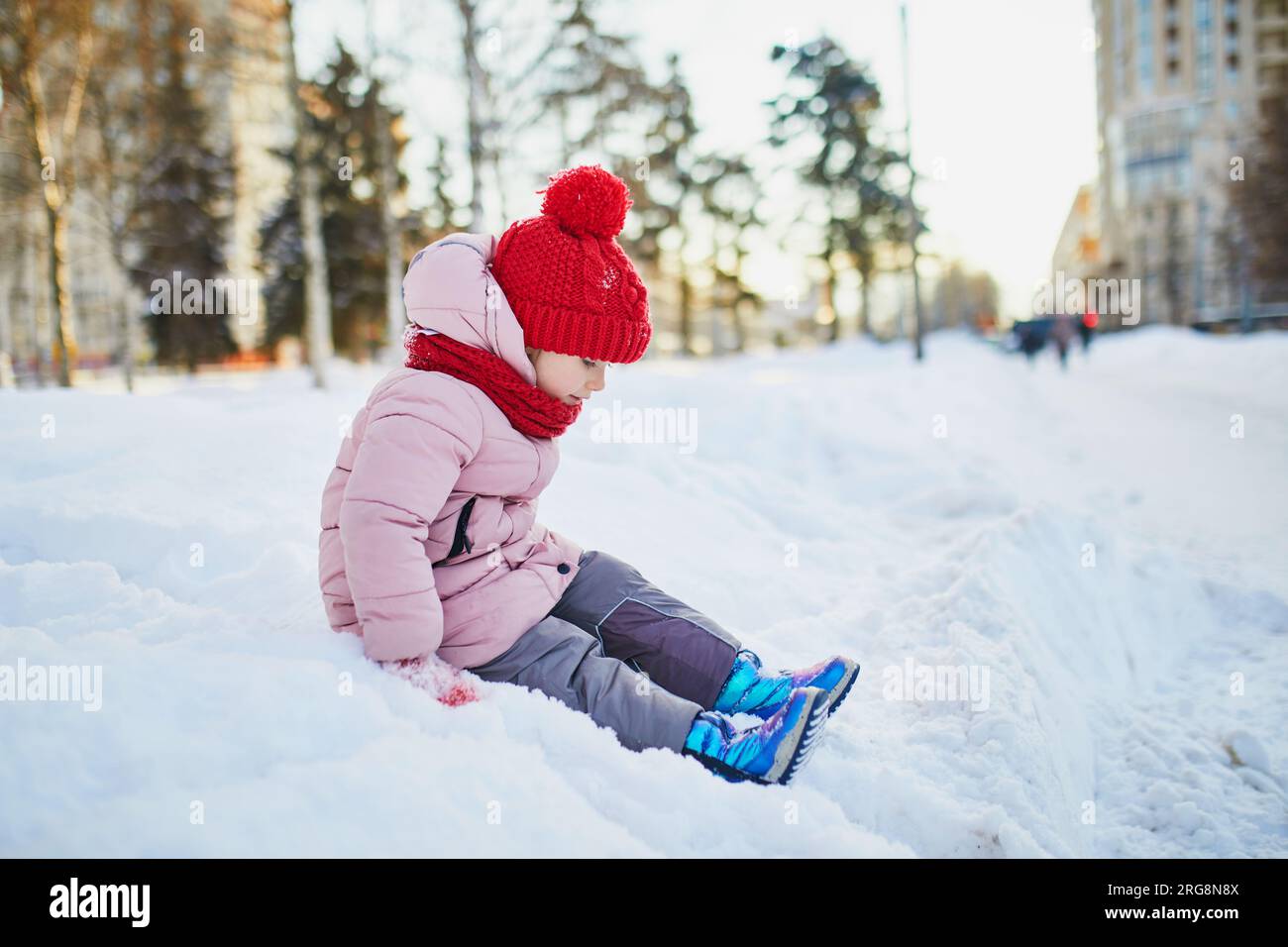 Adorable preschooler girl having fun in beautiful winter park on a ...