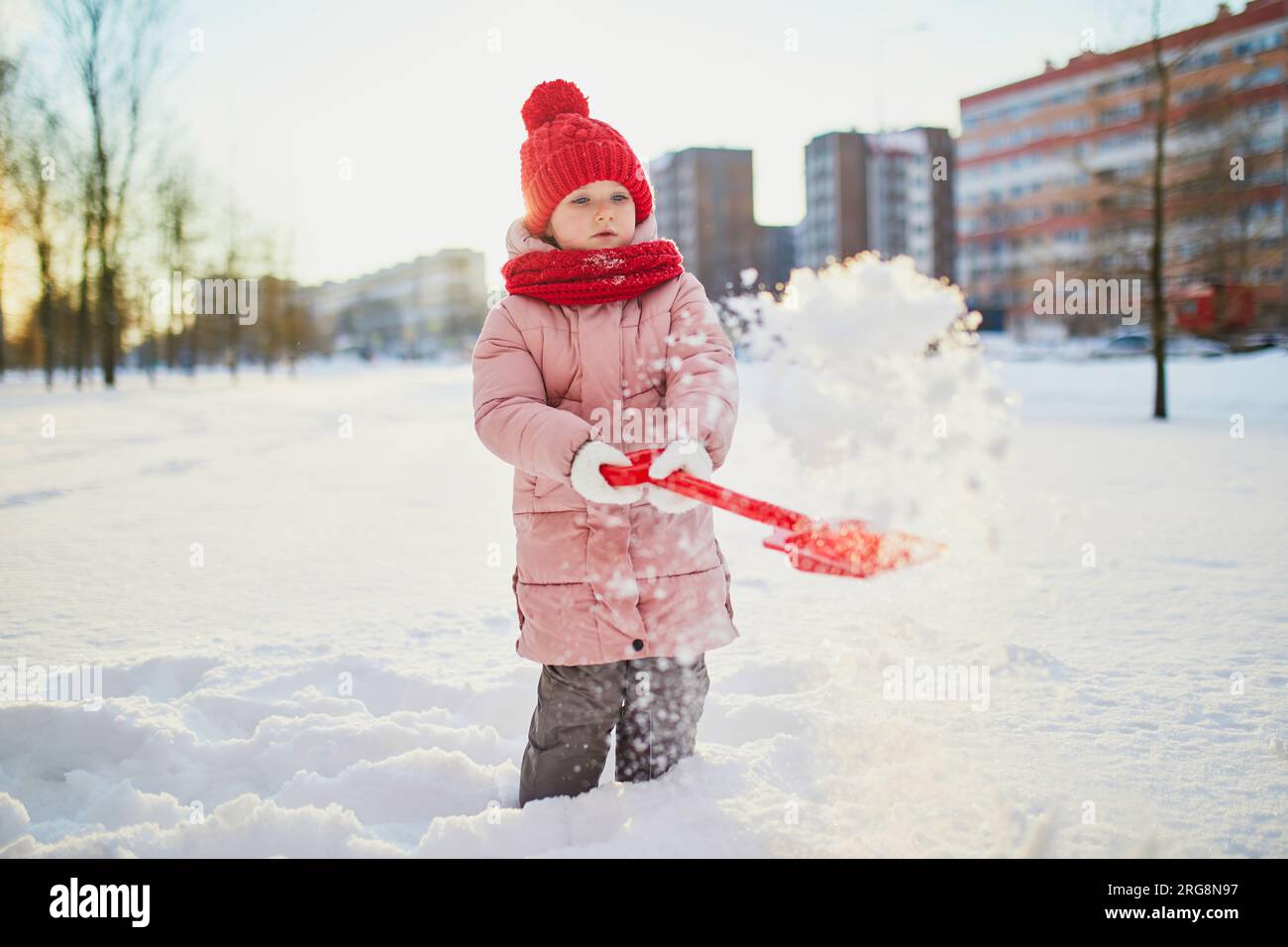 Adorable preschooler girl having fun in beautiful winter park on a ...