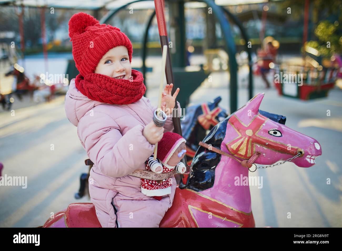 Girl riding on merry go round hi-res stock photography and images - Alamy