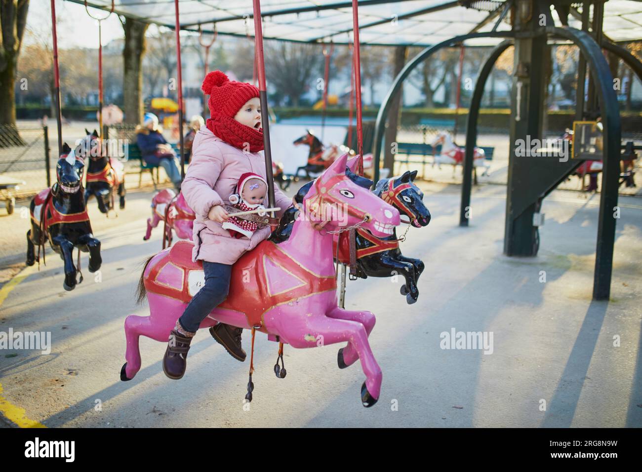 Girl riding on merry go round hi-res stock photography and images - Alamy