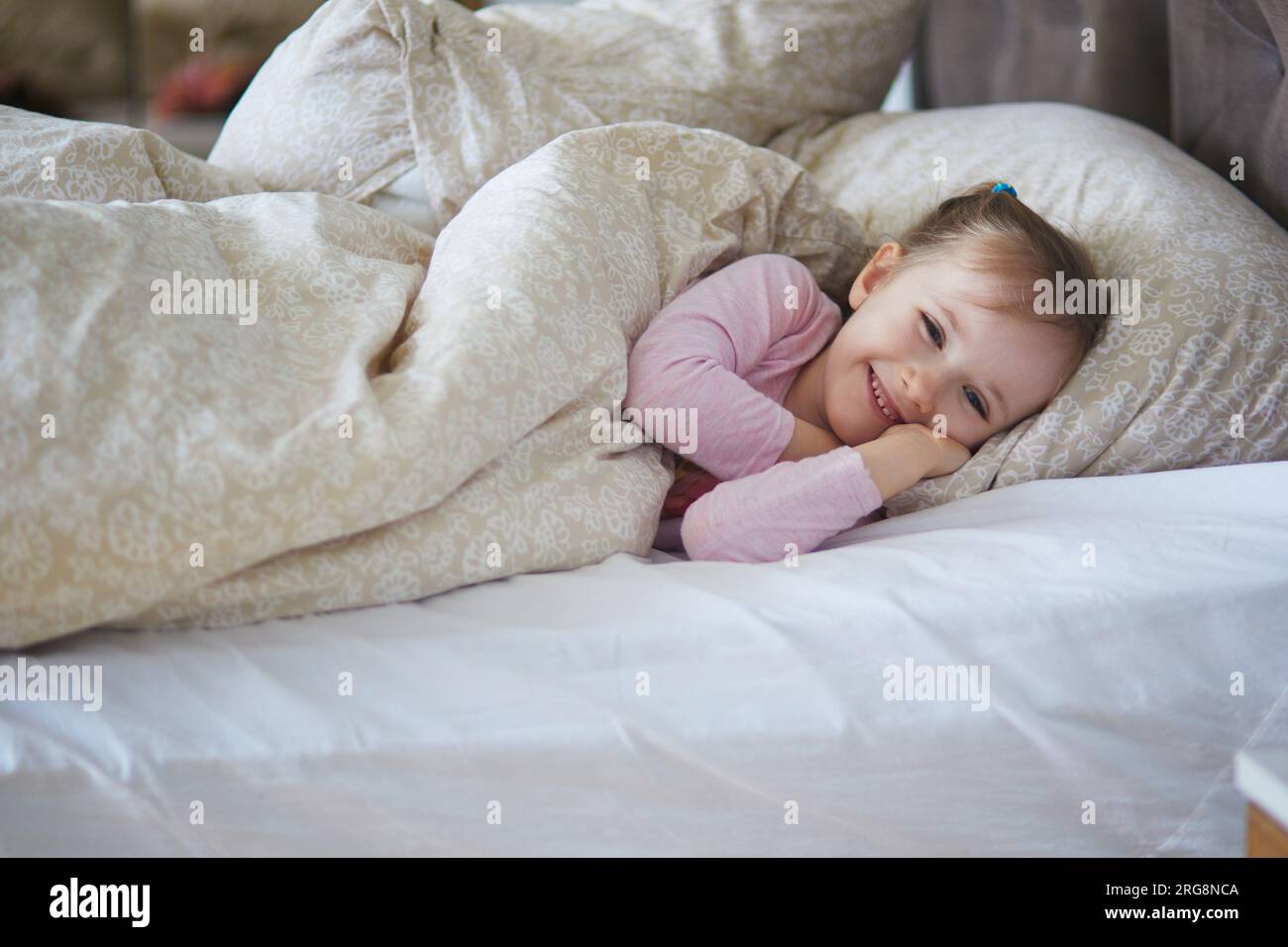 Adorable preschooler girl having a day nap. Little child sleeping in ...