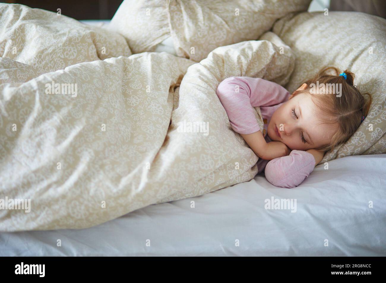 Adorable preschooler girl having a day nap. Little child sleeping in ...