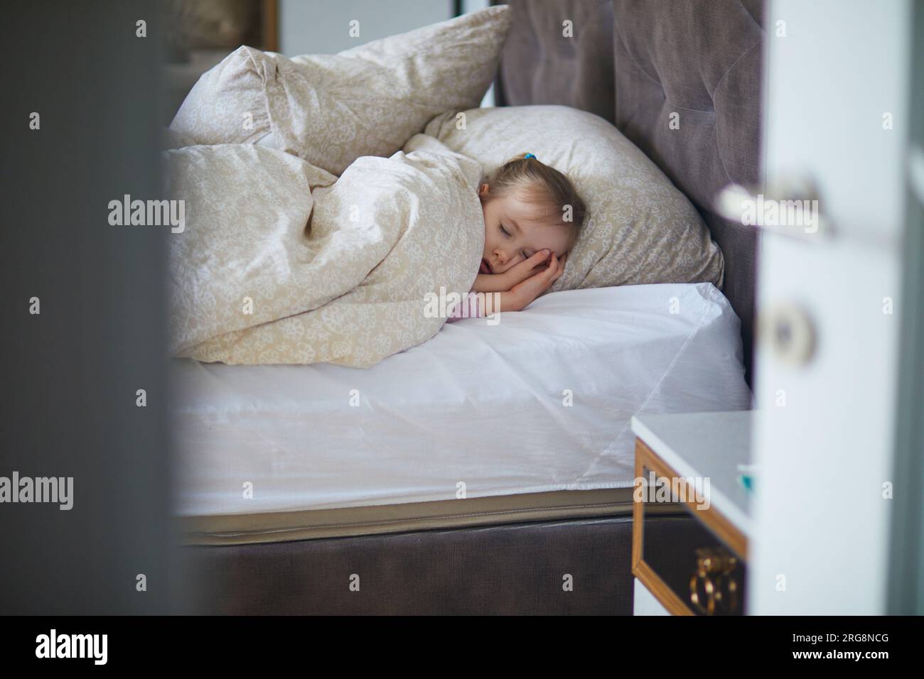 Adorable preschooler girl having a day nap. Little child sleeping in ...