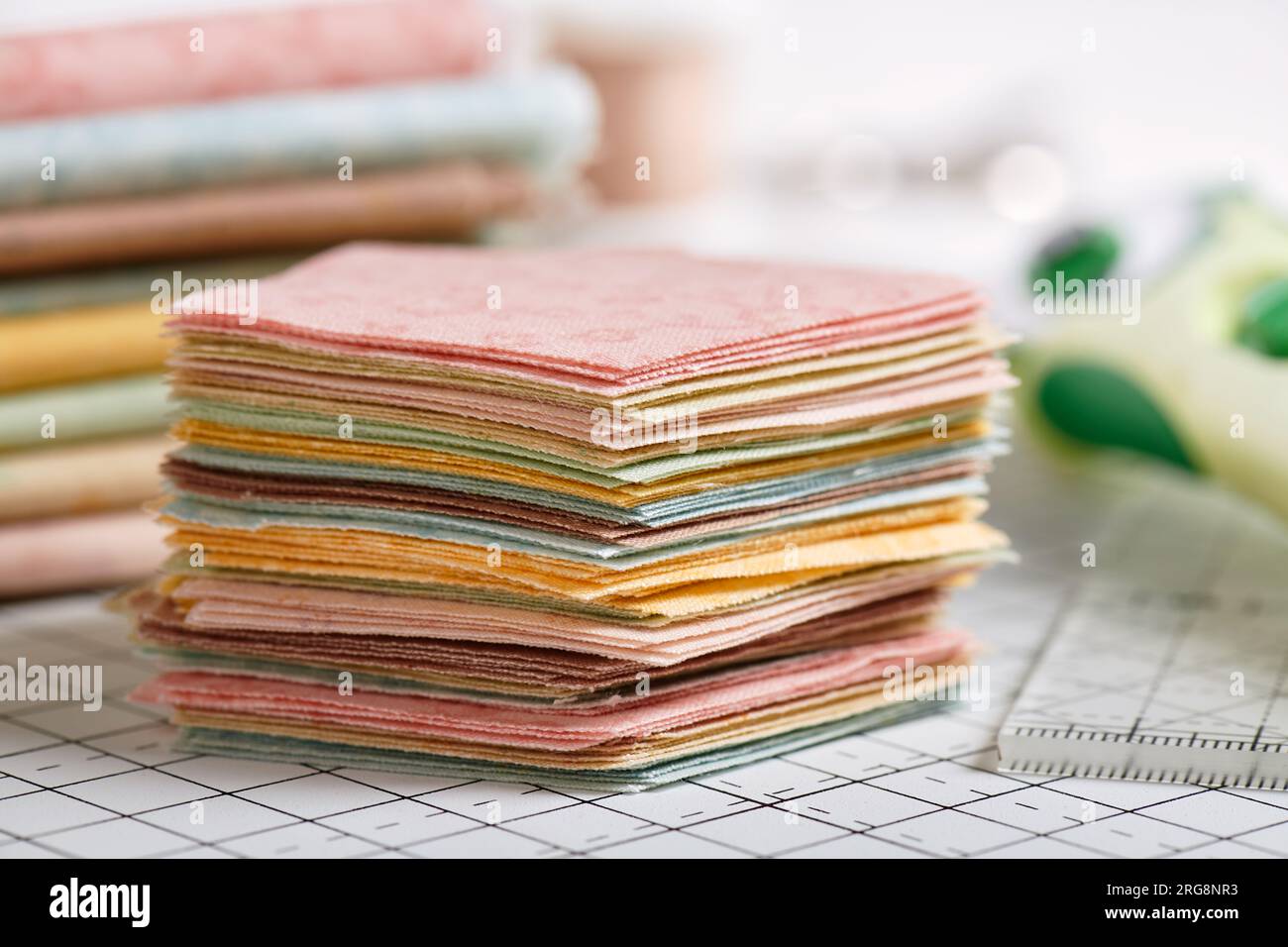 Stack of pentagon pieces of fabrics on white craft mat Stock Photo - Alamy