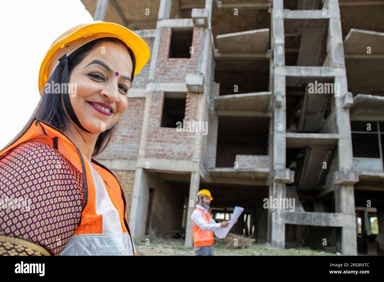 Portrait of smiling young beautiful Indian female civil engineer ...
