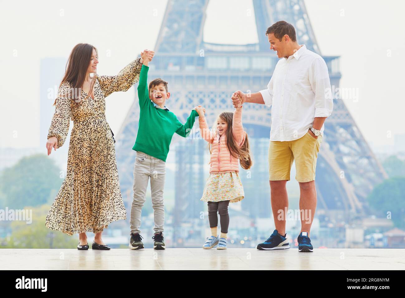Happy family of four enjoying their trip to Paris, France. Mother ...
