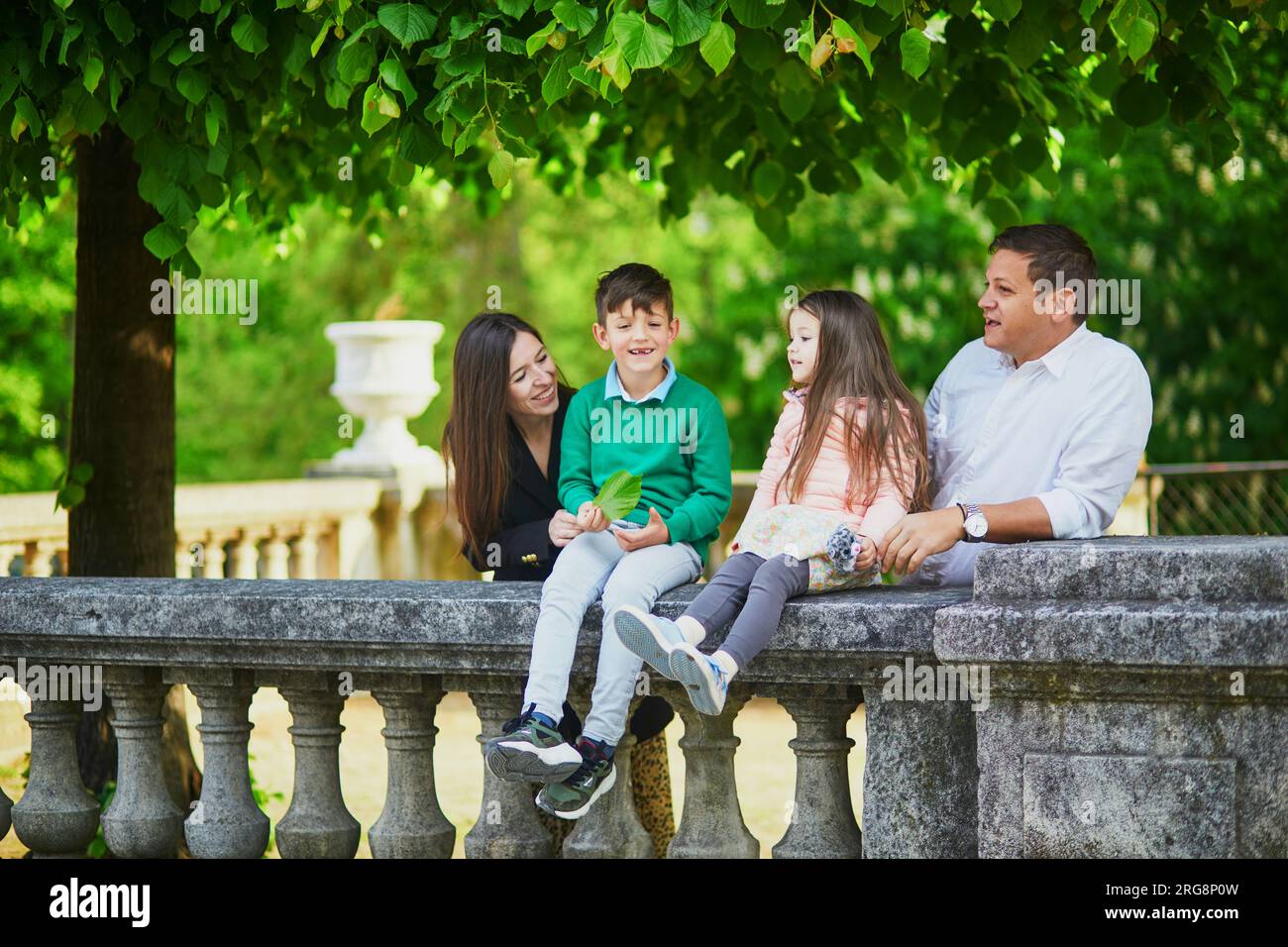 Happy family of four enjoying their trip to Paris, France. Mother ...