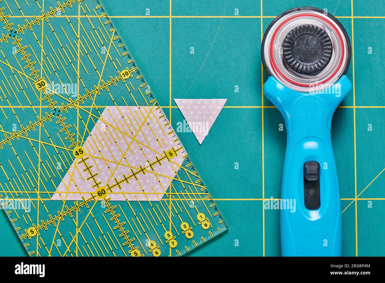 The process of cutting pieces of fabric in the shape of hexagons to ...