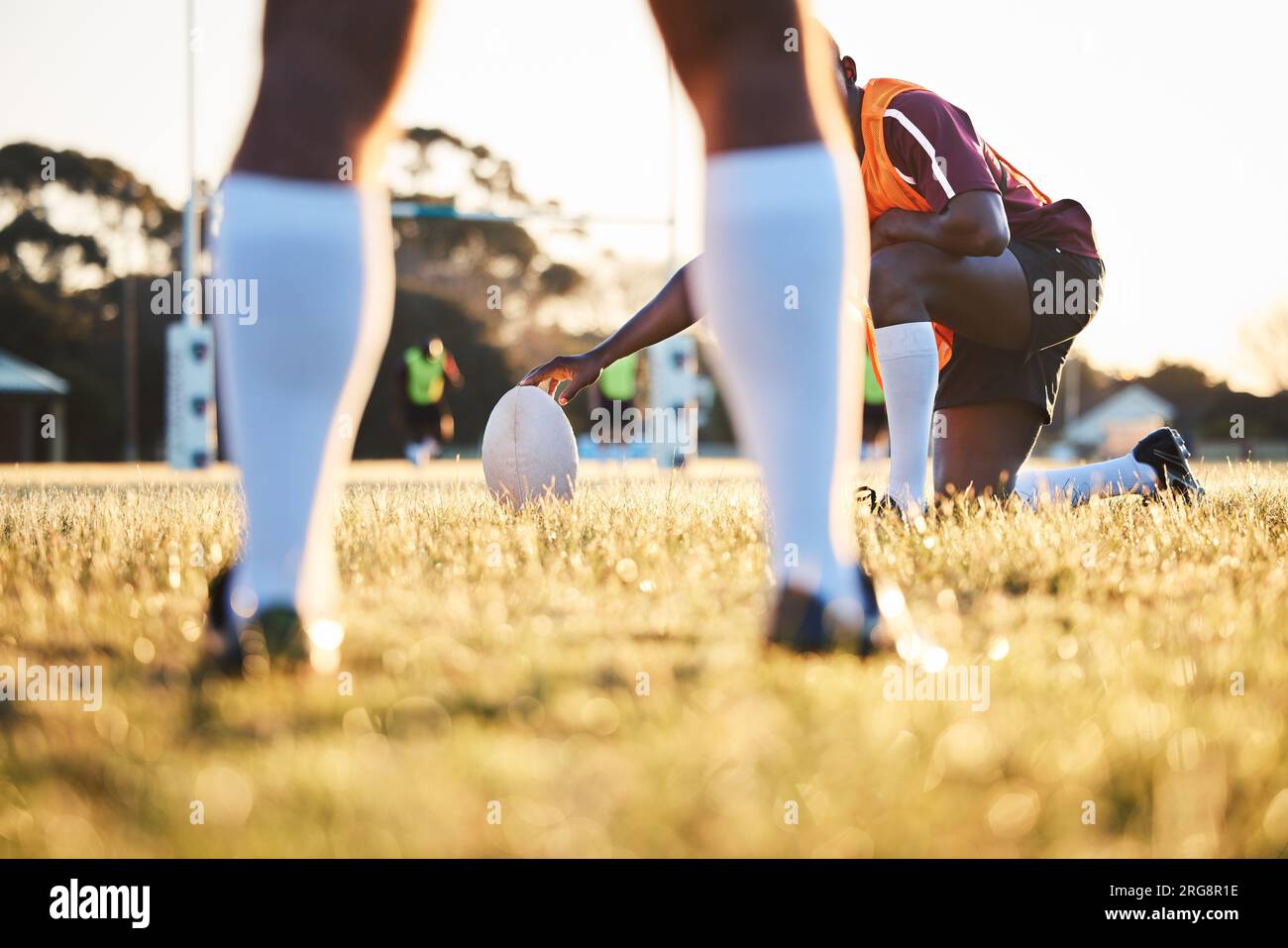 Legs, ball and rugby, sports on field outdoor with team, target with ...