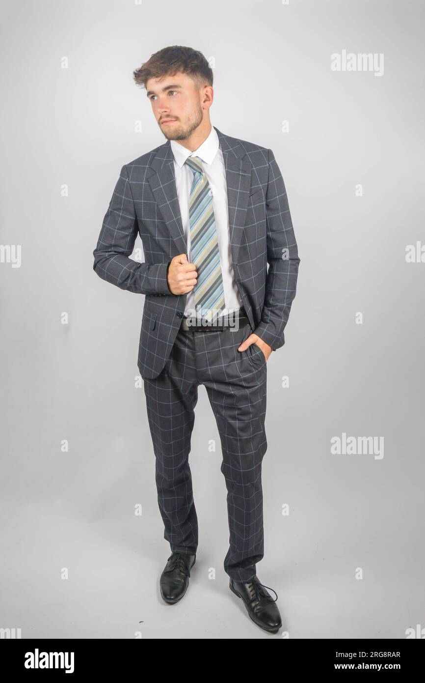 Full length portrait of a young entrepreneur in a suit and tie holding ...