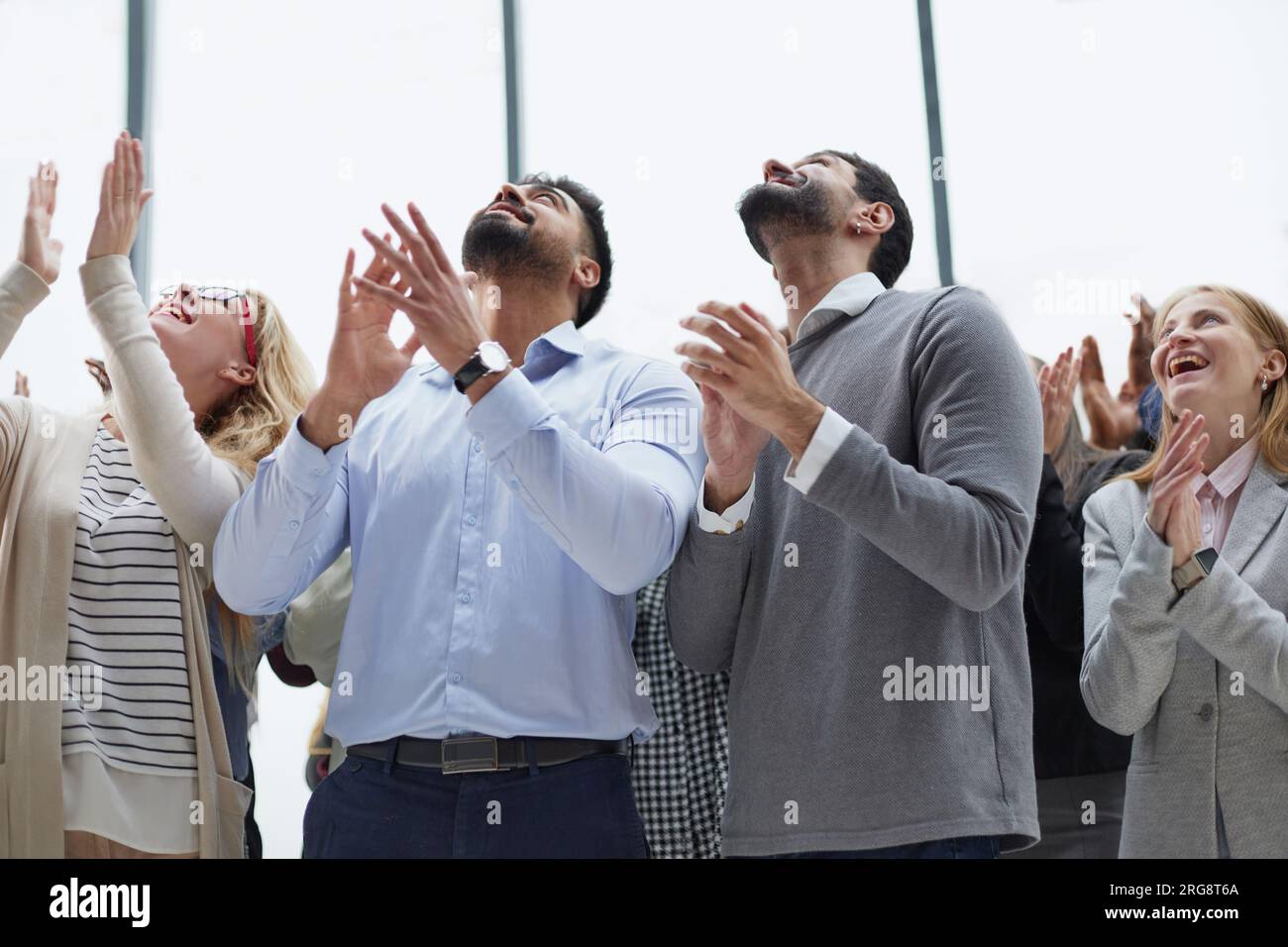 large group of diverse young people looking up hopefully Stock Photo ...
