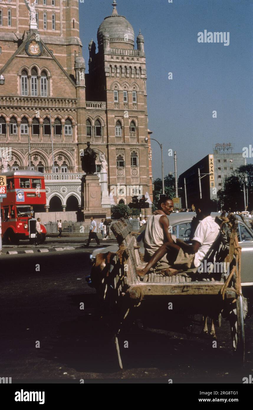 Contrasting Bombay - a horse and cart and a London bus share the road ...