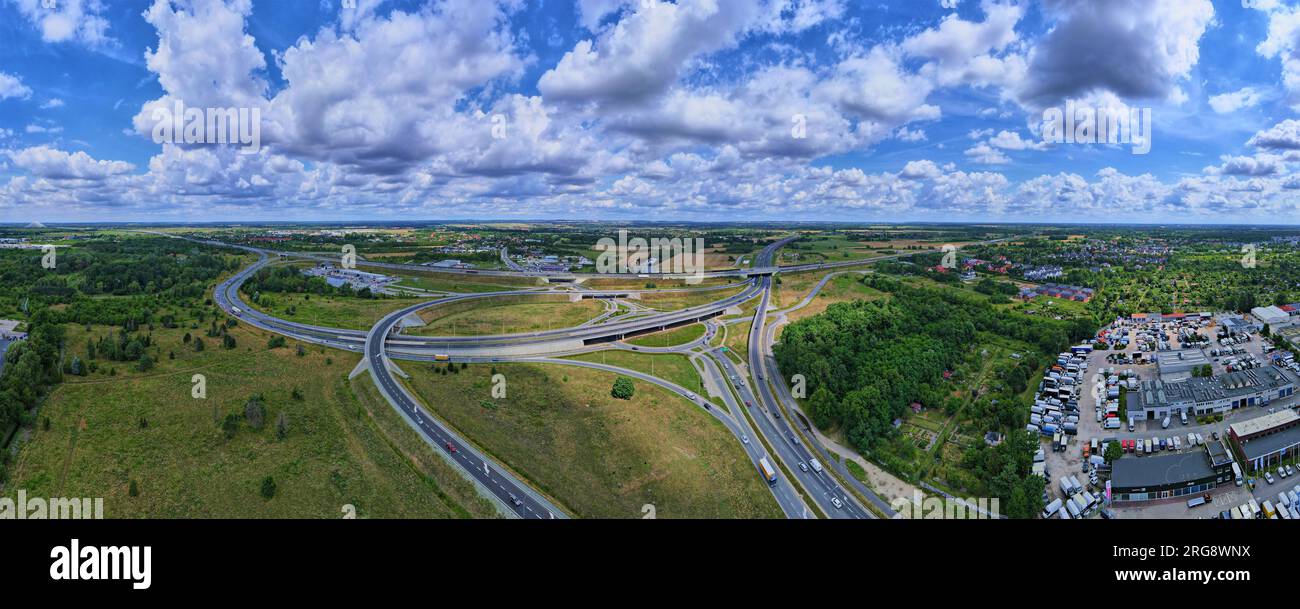 Aerial view of roundabout intersection with driving cars. Car traffic on highway with junction ...