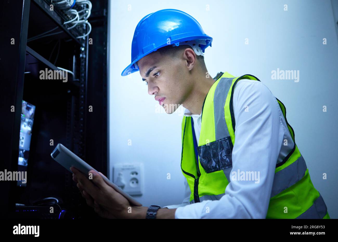 Man, electrician and tablet for power maintenance, server room or data ...
