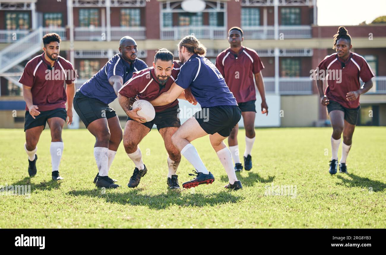 Rugby, fitness and tackle with a team on a field together for a game or ...