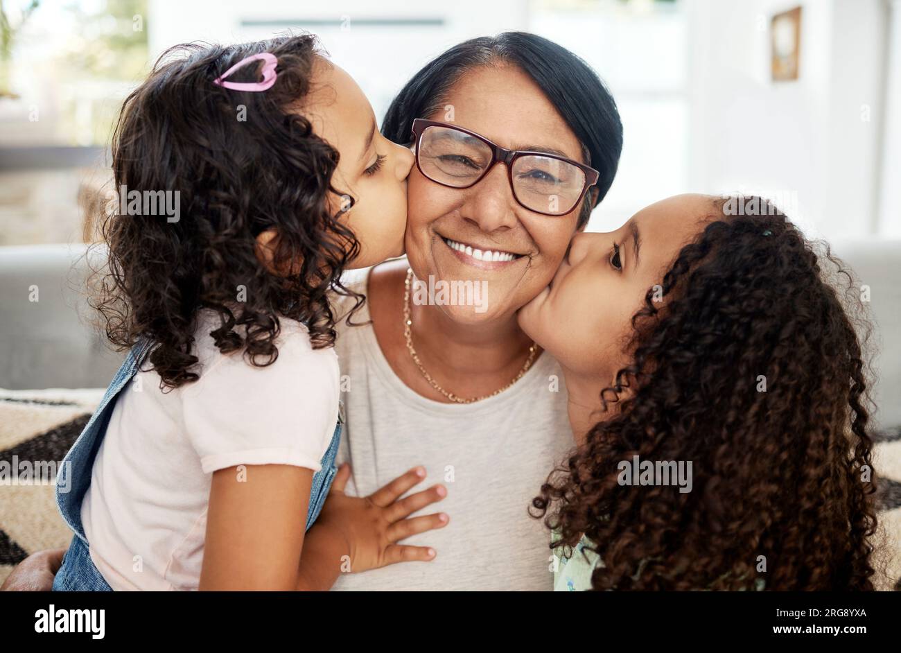 Children kissing their grandmother on her cheek with love, care and ...