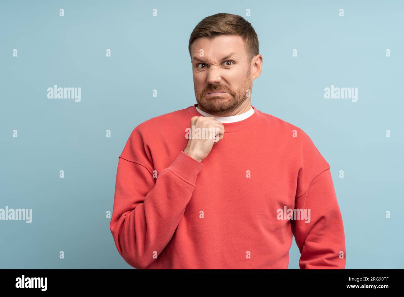 Emotion of disgust on face of young man. Guy looks at camera ...