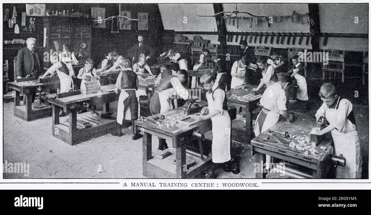 Boys at workbenches learning how to use plane Stock Photo - Alamy