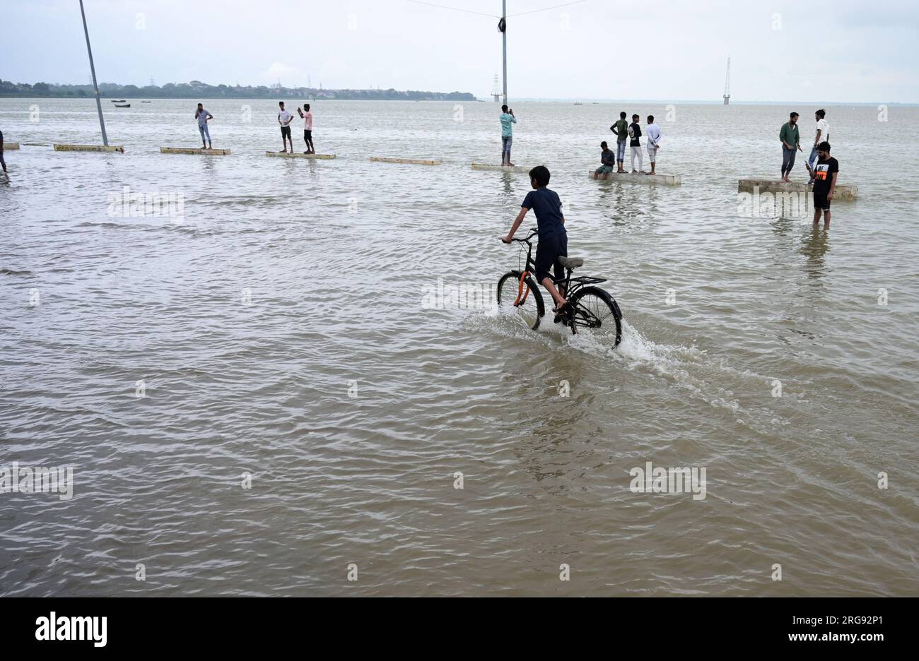 Children rides on a flooded street adjoining with holy river Ganges in ...