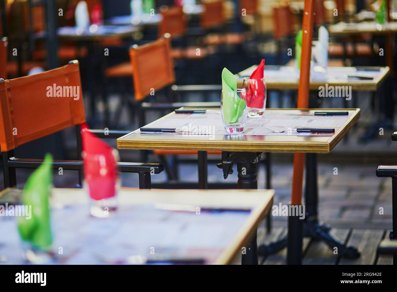 Table of traditional Parisian outdoor cafe. Empty restaurant waiting ...