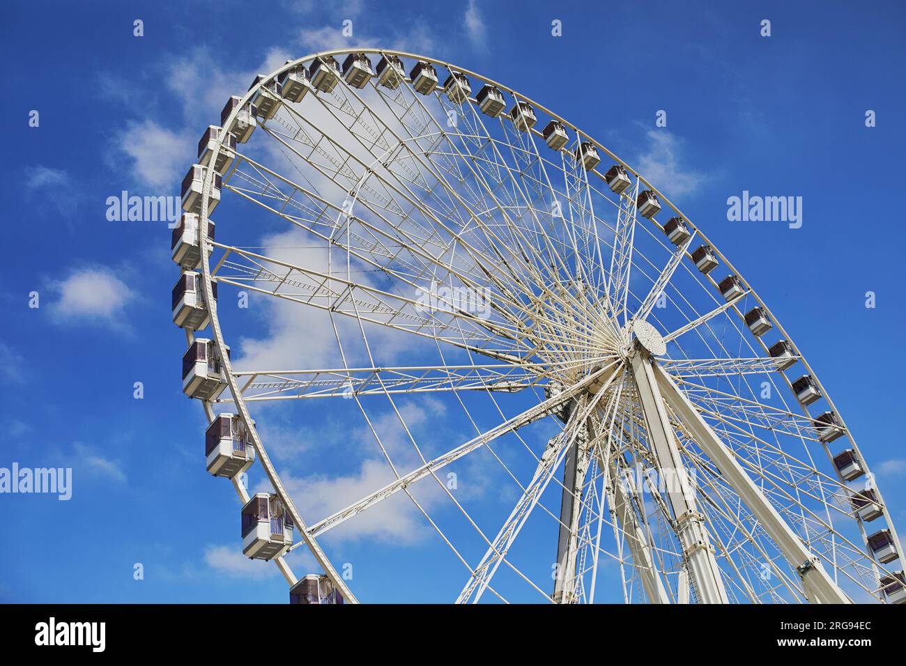 Gondolas of large Ferris Wheel over the blue sky Stock Photo - Alamy