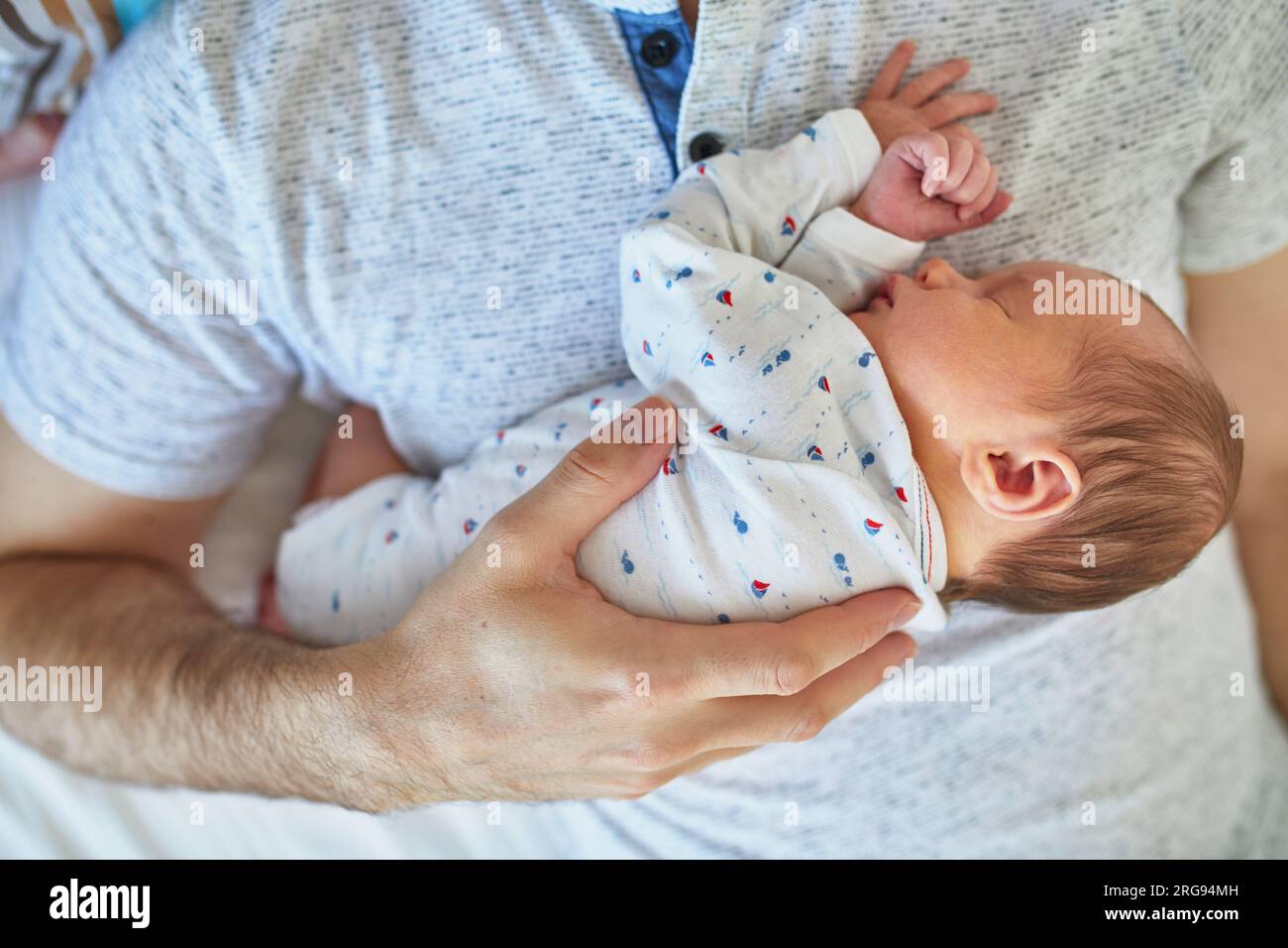 Adorable newborn baby girl sleeping on her father's chest Stock Photo ...