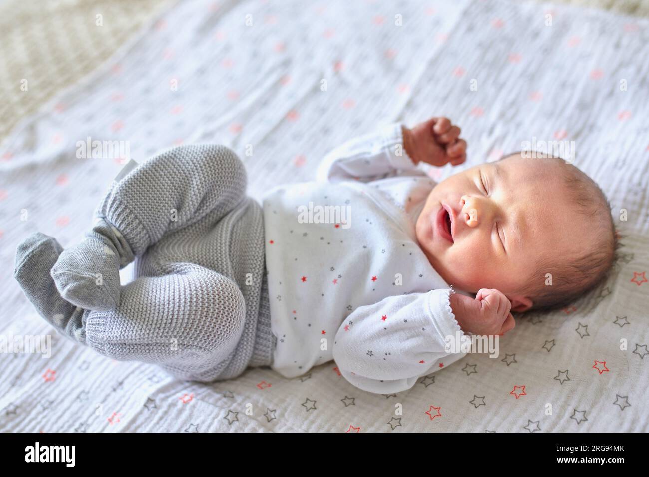 Newborn baby girl sleeping in bed hi-res stock photography and images - Alamy