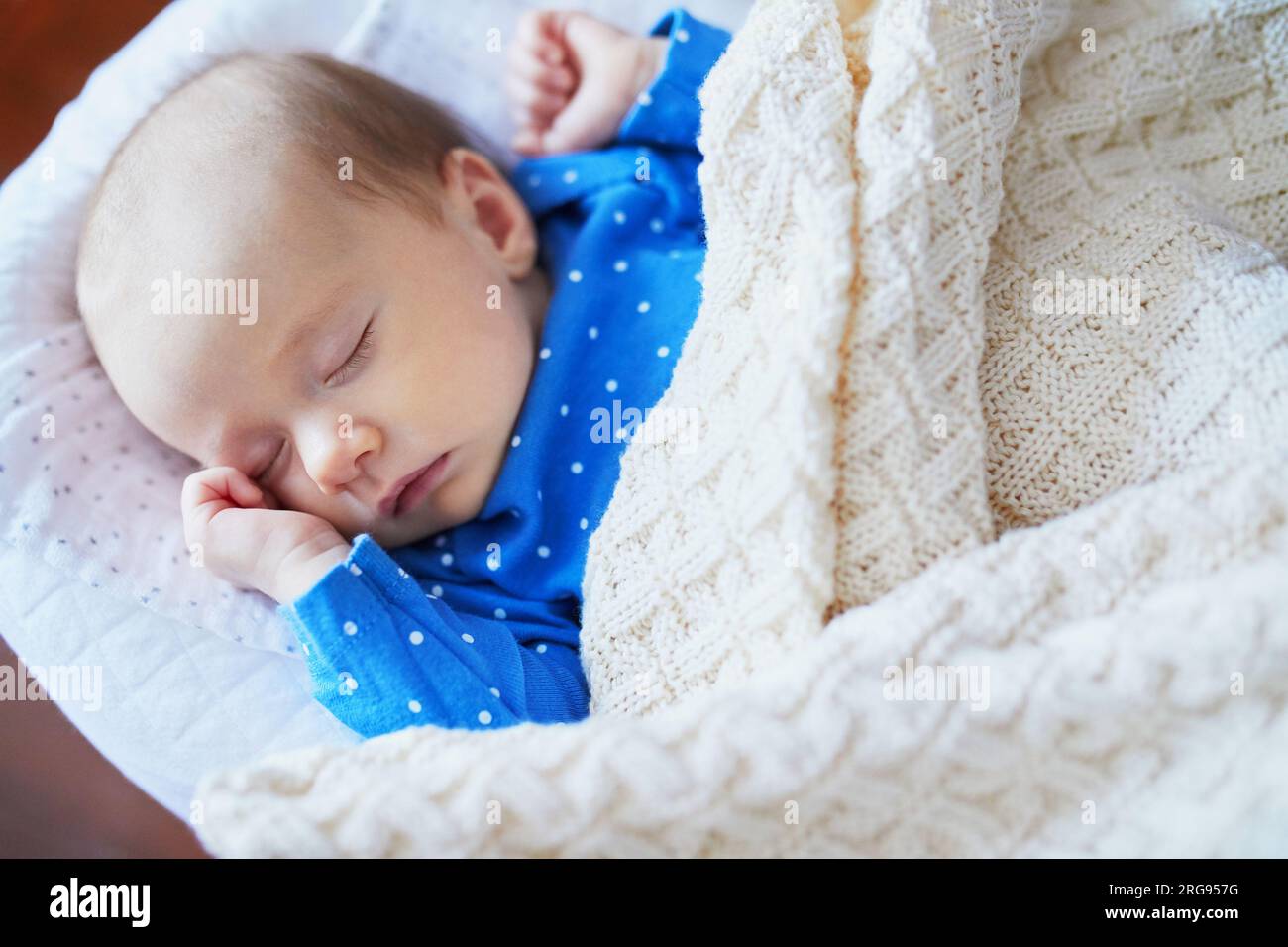 Adorable baby girl sleeping in the crib. Little child having a day nap ...