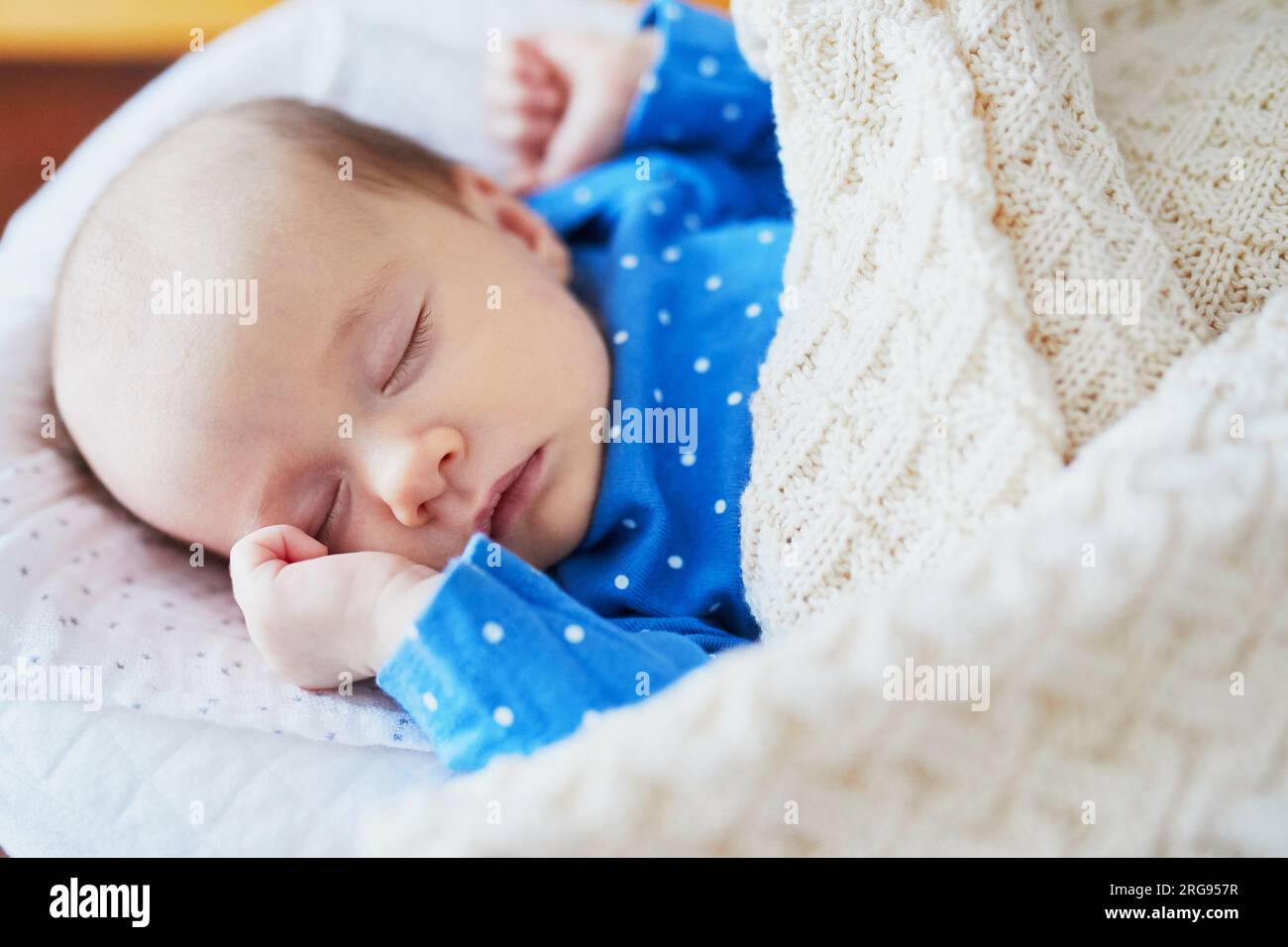 Adorable baby girl sleeping in the crib. Little child having a day nap ...