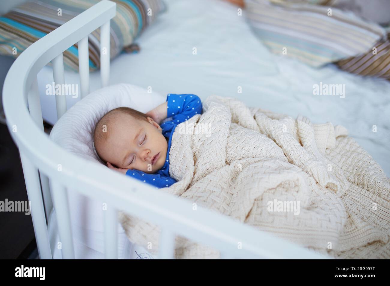 Adorable baby girl sleeping in the crib. Little child having a day nap ...