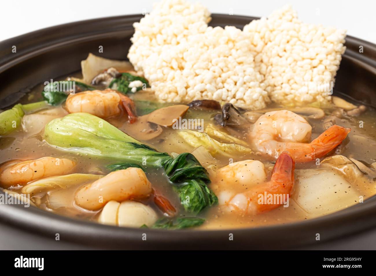 Fried glutinous rice soup with seafood on white background Stock Photo ...