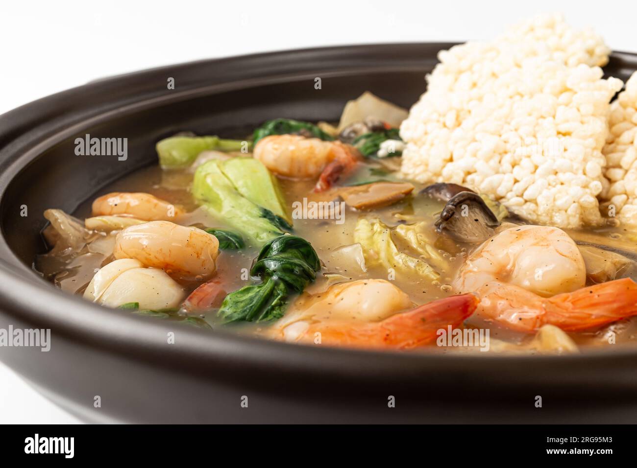 Fried glutinous rice soup with seafood on white background Stock Photo ...