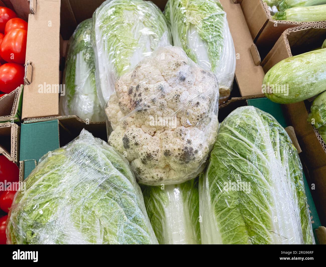 Tainted cauliflower. Black mold on bad cauliflower. Improper storage of ...