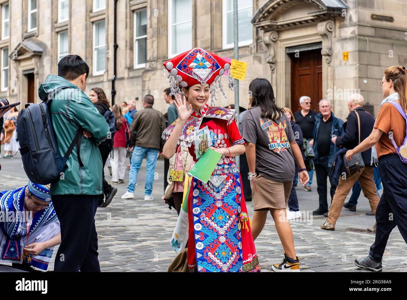 People in costumes handing out flyers of some of the shows of the ...