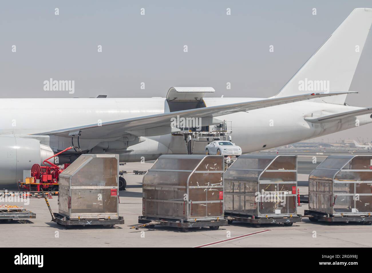 Loading a car into a cargo airplane. Freight aircraft ground handling ...