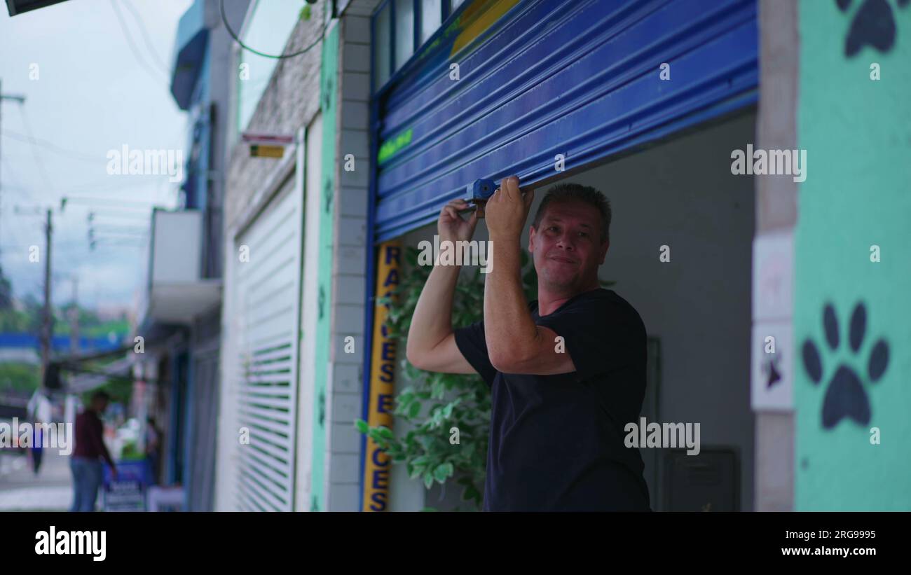 Man closing storefront garage in hi-res stock photography and images ...