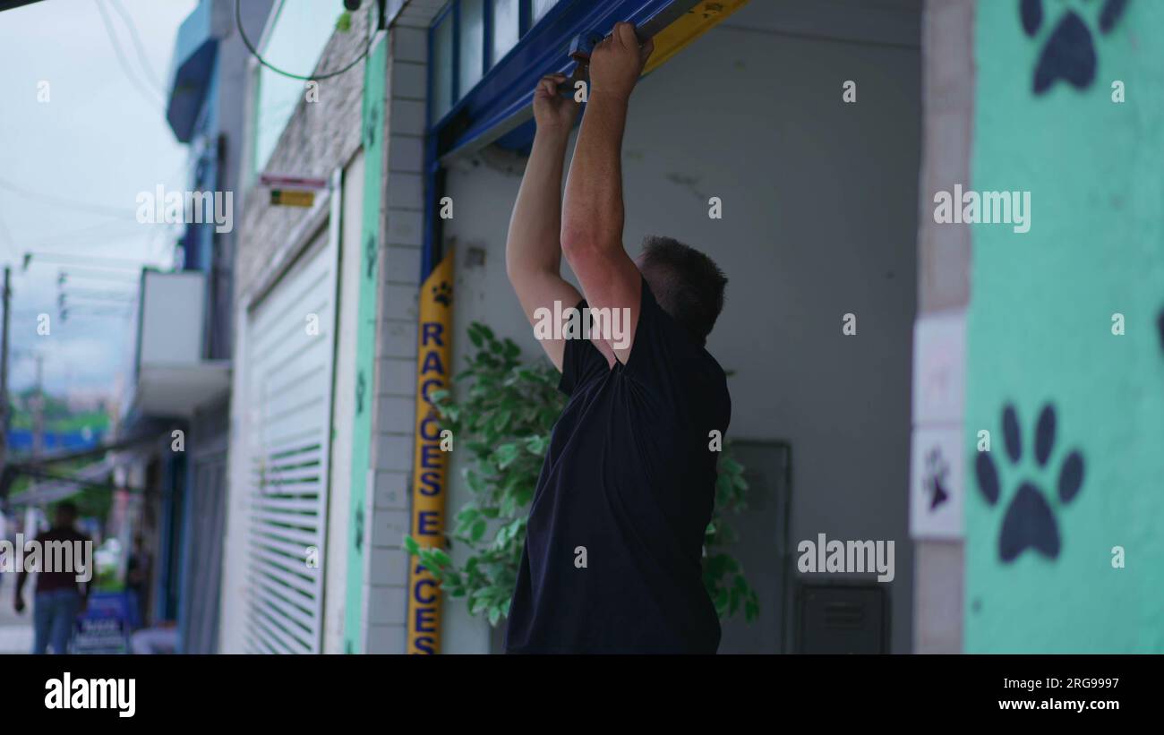 Man closing storefront garage in hi-res stock photography and images ...