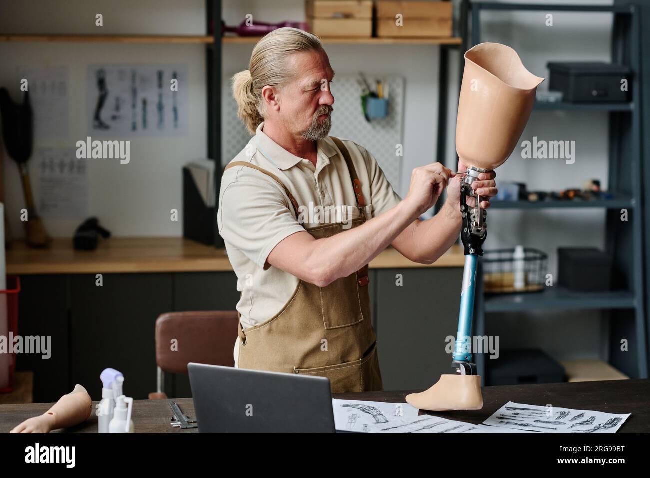 Side view portrait of long haired senior craftsman building handmade ...