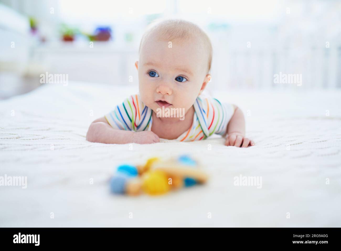 Baby girl learning to crawl. Little child doing tummy time. Infant kid ...